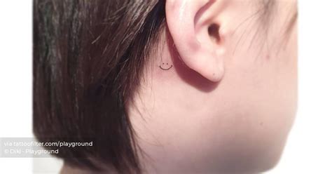 Tiny Minimalistic Smiley Face Tattoo Located Behind The