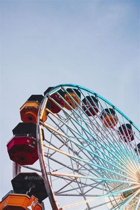 Vertical View Of A Colorful Carrousel Against The Blue Sky Dreamy Background Stock Photo By