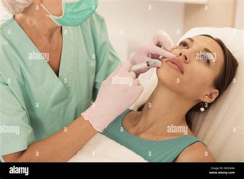 Young Woman Getting Injection For Facial Correction Procedure In