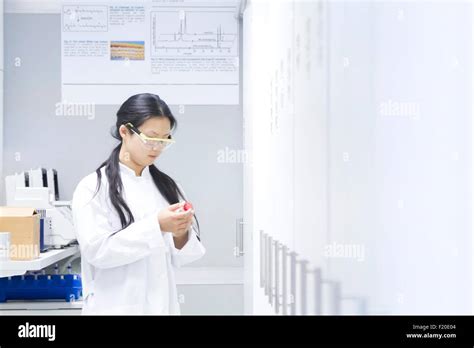 Female Scientist Reading Specimen Label In Laboratory Stock Photo Alamy
