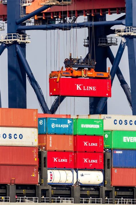 Crane Operator Unloading A Sea Container From A Cargo Ship In The Port Of Rotterdam March 16