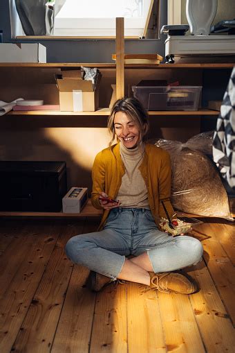 집 이사 바닥에 앉아 있는 행복한 여성 휴대 전화를 사용하고 테이크 아웃 식사를 먹는 것 새 집으로 이사에 대한 스톡 사진 및 기타 이미지 Istock