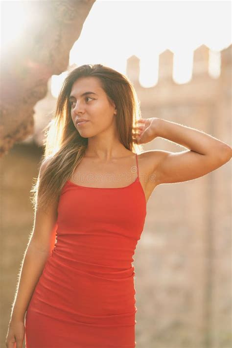 Girl With Tight Red Dress And Long Straight Hair Posing In Toledo Stock