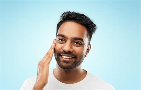 Premium Photo Smiling Indian Man Touching His Face