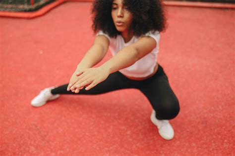 Selective Focus Photo Of Smiling Woman In Red Yoga Pants And Black
