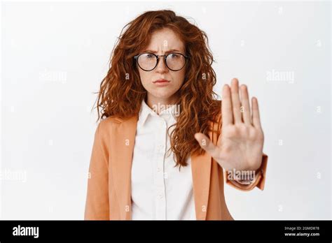 Angry Redhead Trainee Saleswoman Showing Stop No Gesture And Frowning