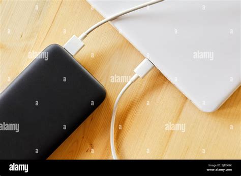 Power Bank Charges A Laptop Via Usb Type C Cable On Wooden Background Stock Photo Alamy