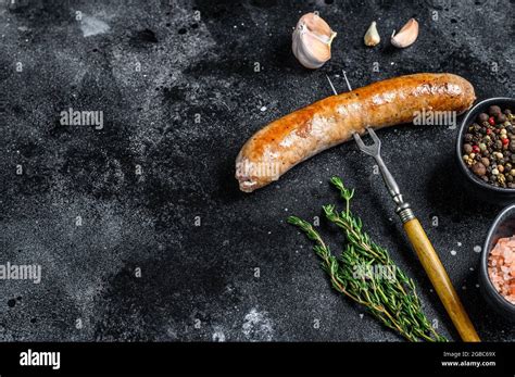 Pork Sausage Bbg Grilled With Spices And Herbs On A Meat Fork Top View