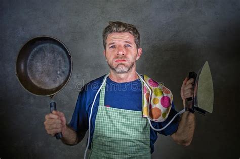 Young Attractive Stressed And Overwhelmed Lazy Man Holding Kitchen Pan