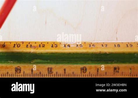 Drawing Straight Line On Wooden Background With Wooden Ruler And Pencil