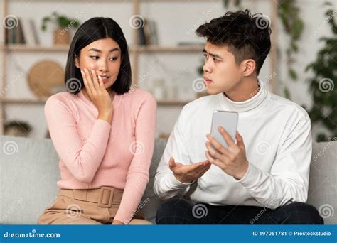 Korean Husband Catching Wife On Cheating Showing Her Phone Indoor Stock