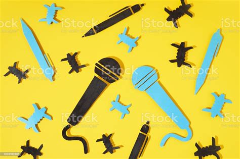 세계 언론 자유의 날 개념 언론의 자유를 상징하는 파란색과 검은색 마이크와 종이로 만든 펜은 철조망과 금지에 저항합니다 노란색 배경입니다 공간을 복사합니다 0명에 대한 스톡