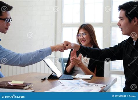Businessman Giving Fist Bump Business Team Touching Hands Together