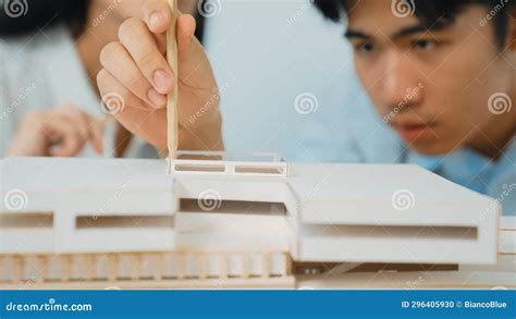 Architect Team Using Pencil To Test House Model Durability Closeup