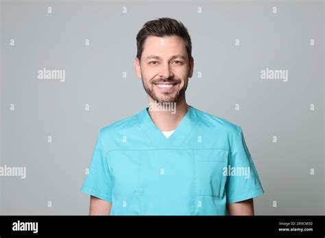 Doctor Or Medical Assistant Male Nurse In Uniform On Light Grey