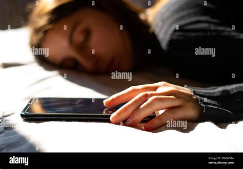 Woman Turning Off The Phone S Alarm Clock In Bed Alarm Clock Concept Stock Photo Alamy