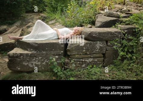 Girl Posing On The Felled Trees Girl Lying On The Remains Of Ancient Buildings Stock Video