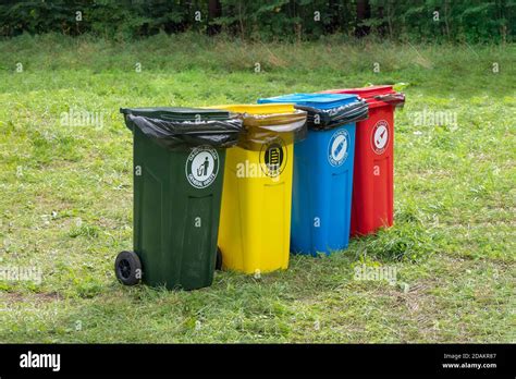 Colored Containers For Separate Garbage Collection In Green Lawn Stock Photo Alamy