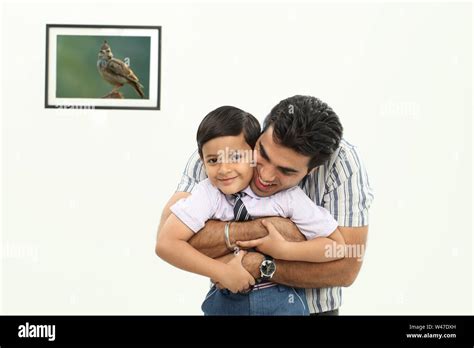 Man Hugging His Son And Smiling Stock Photo Alamy