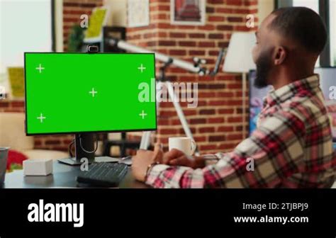 Smiling Employee Looking At Chroma Key Mock Up Computer Green Screen While In Video Conference