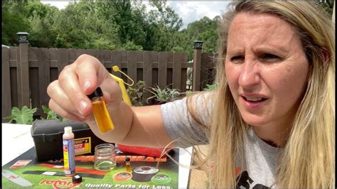 A Woman Holding A Yellow Object In Her Right Hand And Pointing It At The Camera