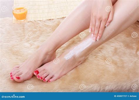 The Beautiful Legs Of The Girl Smeared With White Cream Stock Image
