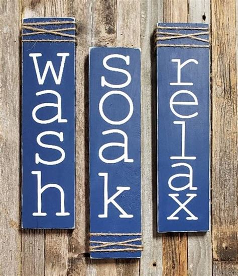 Two Blue Wooden Signs That Say Wash Soap And Wax On Wood Planks