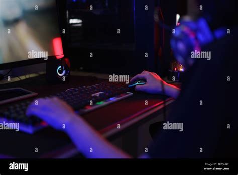 female cyber hacker gamer using keyboard and mouse to playing games or