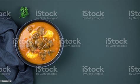 어두운 배경에 헝가리어 굴 라시 감자 당근 파프리카 향신료 및 마늘을 곁들인 쇠고기 스튜 평면도 복사 공간 0명에 대한 스톡