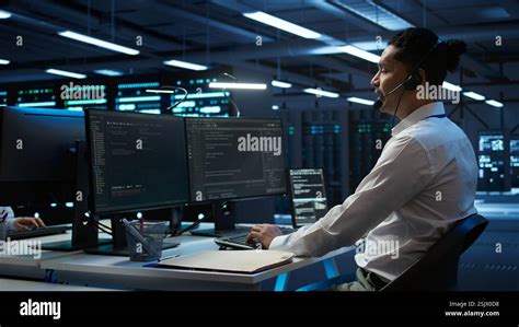 data center computer scientist wearing mic headset doing installation of networking equipment