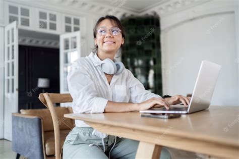 Premium Photo A Female Programmer Routine Working Online On Her Project Site Uses A Laptop