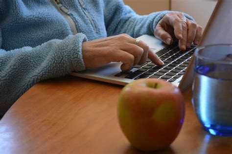 Premium Photo Hands Typing On Laptop Keyboard Low Angle View With An