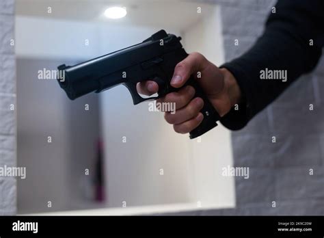 Threat Of Firearms Muzzle Of Gun In Mans Hand Is Pointed At Camera