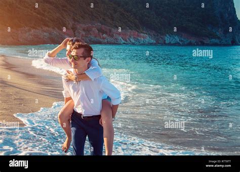 Young Happy Couple In Love Having Fun On Tropical Beach In The Morning