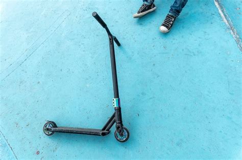 Premium Photo The Scratched Scooter Lies After Falling To The Ground