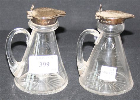 A Pair Of George V Silver Mounted Clear Glass Whisky Tots Of Conical