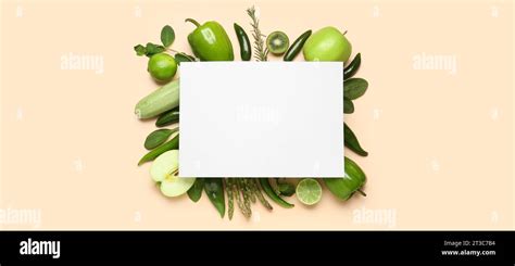 Different Green Vegetables Fruits And Blank Paper Sheet On Beige