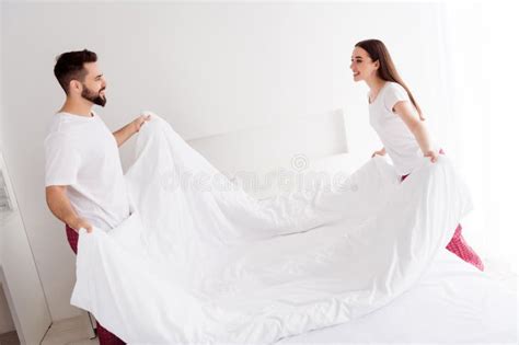 Photo Of Excited Good Mood Husband Wife Nightwear Making Bed Indoors