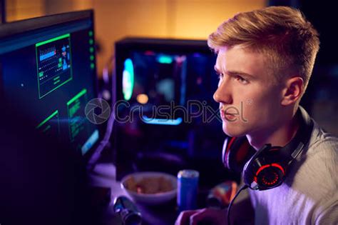 Male Teenage Hacker Sitting In Front Of Computer Screens Bypassing Stock Photo 1711418