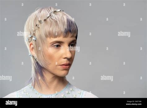 A Side Profile Portrait Of A Young Woman With Blonde Hair And Purple