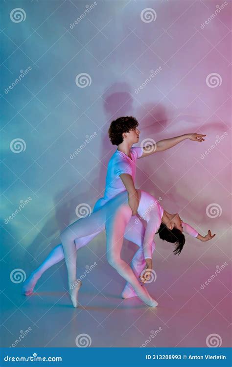 Dramatic Ballet Lift Male Supporting A Poised Female Dancer Both In