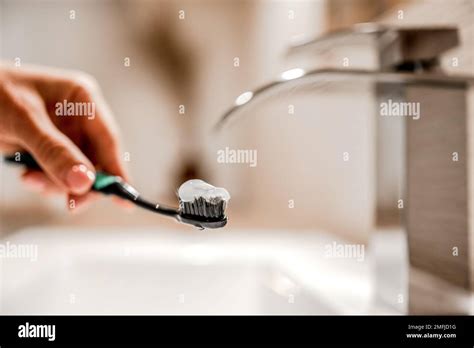 Girl Hand Holding Tooth Brush With Paste Under Running Water Stock