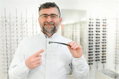 Handsome Ophthalmologist Holding Eyeglasses For A Try Out Optometrist