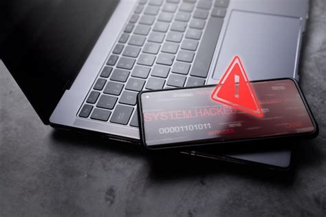 Premium Photo Smartphone Laying On Laptop With Red Warning