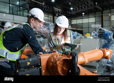 Both Of Engineers Working Together In A Robotic Arm Factory Robotic Arm Industry And