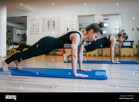 Two Young Females Doing Extended Plank Static Strengthening Core
