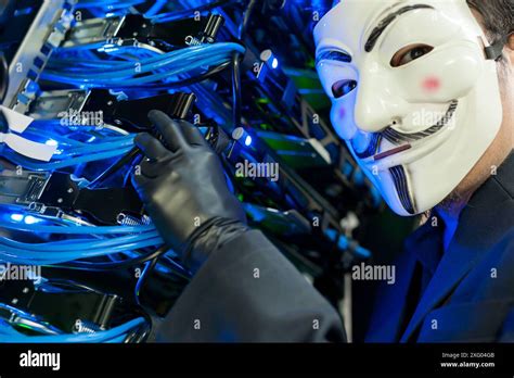 Masked Hacker In Computer Server Room Concept Editorial Photo Stock
