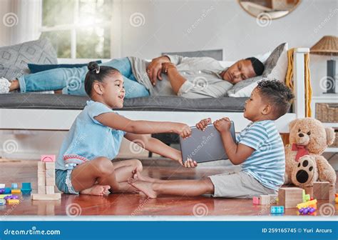 Dad Says Its My Turn Two Siblings Fighting Over A Digital Tablet On