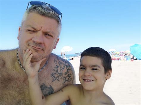Premium Photo Portrait Of Father And Son At Beach