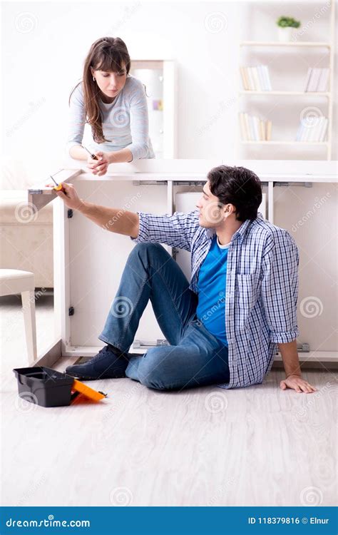 The Husband Repairing Broken Table At Home Stock Photo Image Of Handyman Cabinet